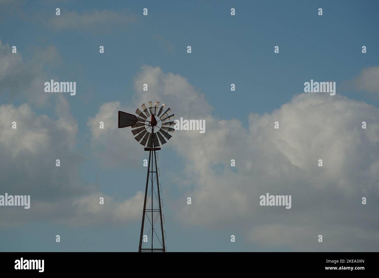 water wind mill on cloudy sky background Stock Photo - Alamy