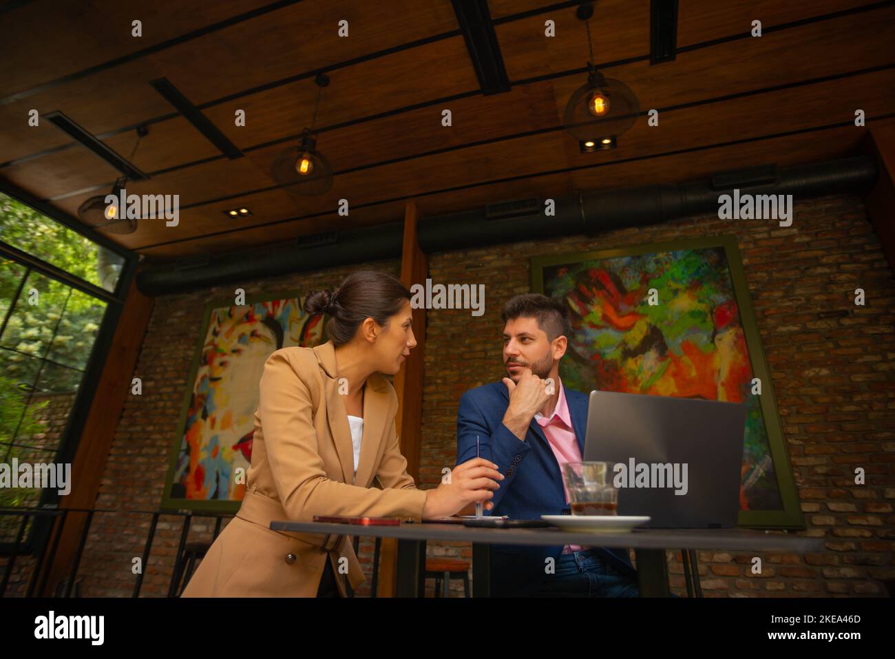 An attractive business people are sitting and having nice conversation ...