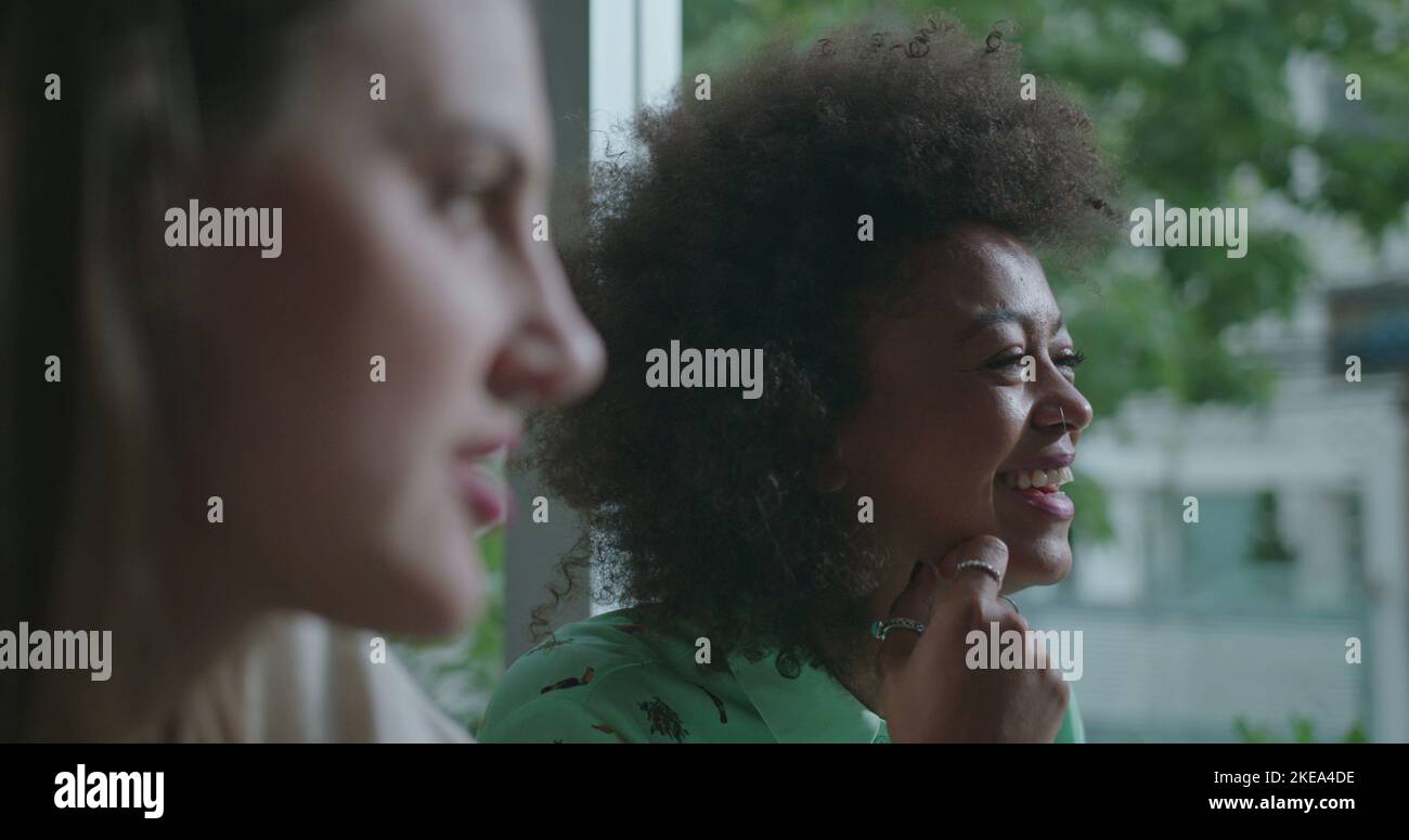 Two happy diverse women speaking in conversation. Closeup female faces ...