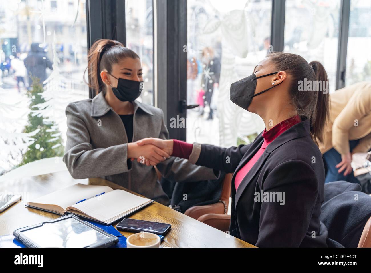 Two attractive and beautiful women are making a deal for partnership ...