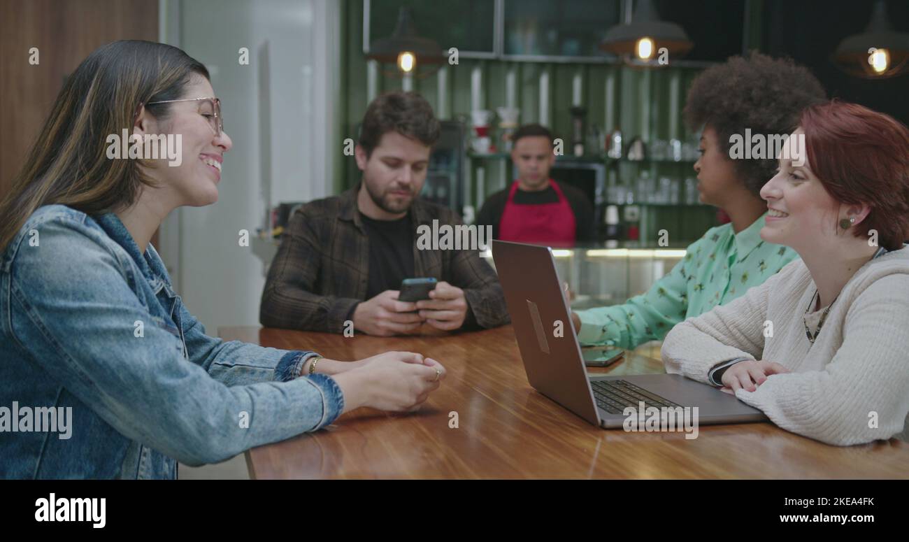 People chatting inside coffee shop business place. Group of friends ...