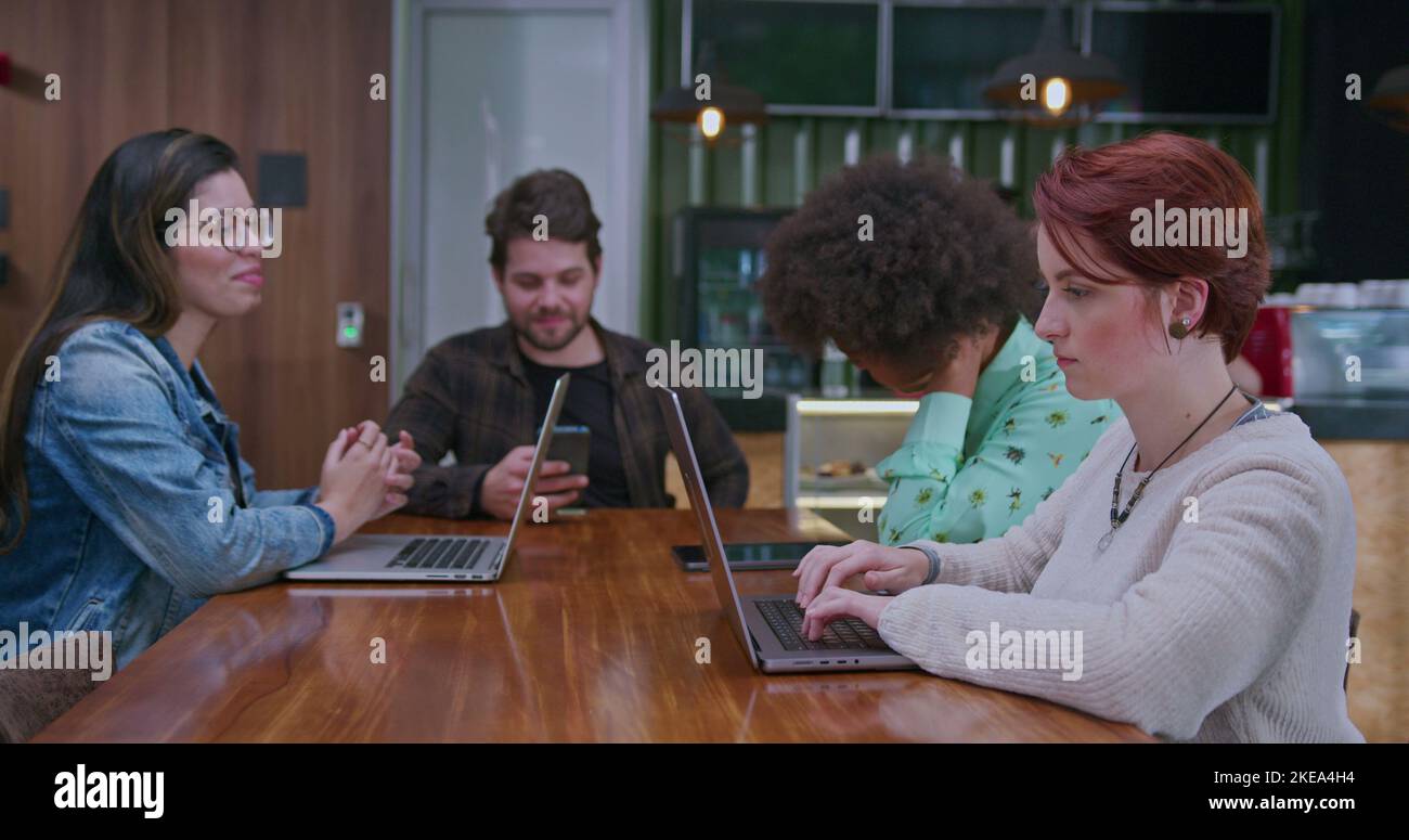 People using devices at coffee shop interior. Group of work colleagues ...