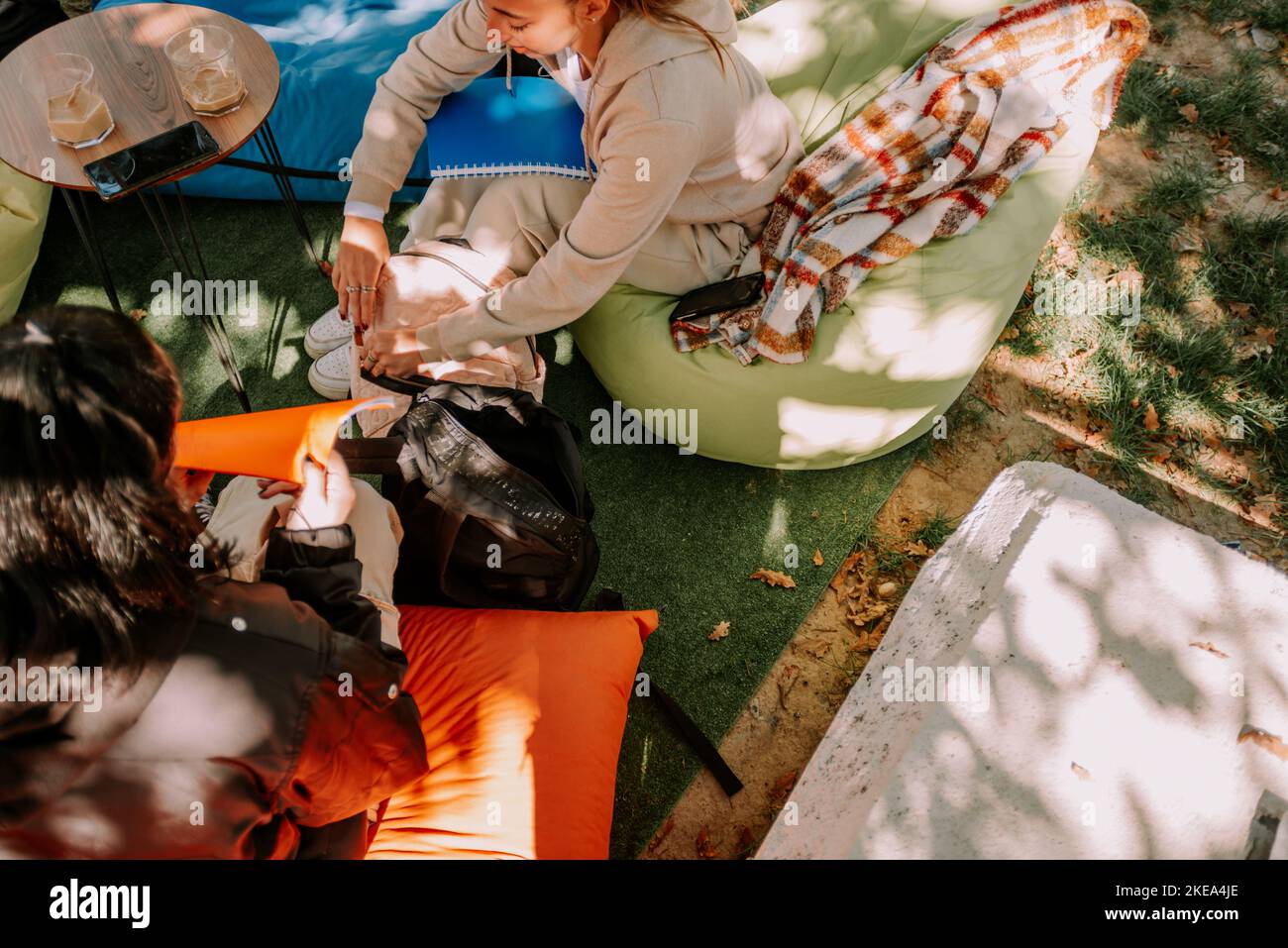 A hipster high school girls are about to study together in a coffee bar ...