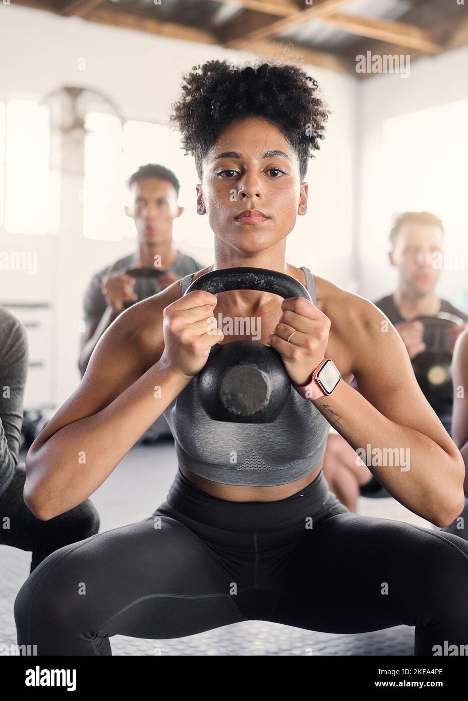 Kettlebell, fitness and black woman gym personal trainer with sport class doing gym training ...