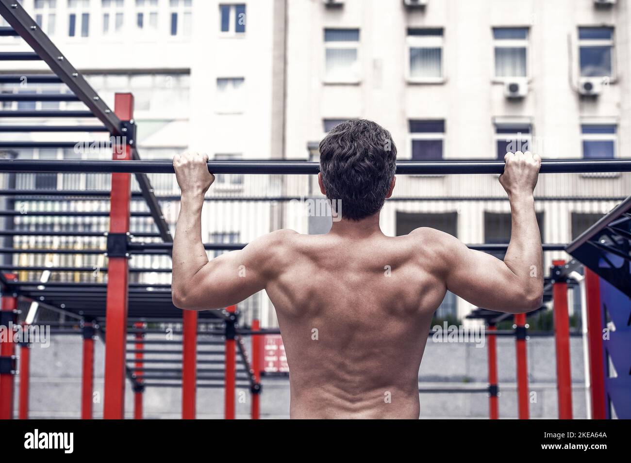 Man muscular back athlete doing pull ups with proper form, sport ...