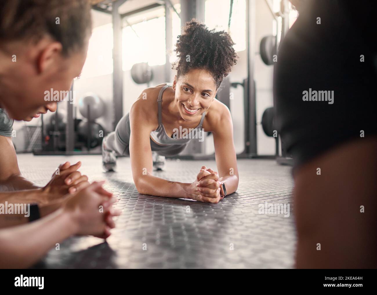 Happy black woman, group and plank in gym for health, fitness and ...
