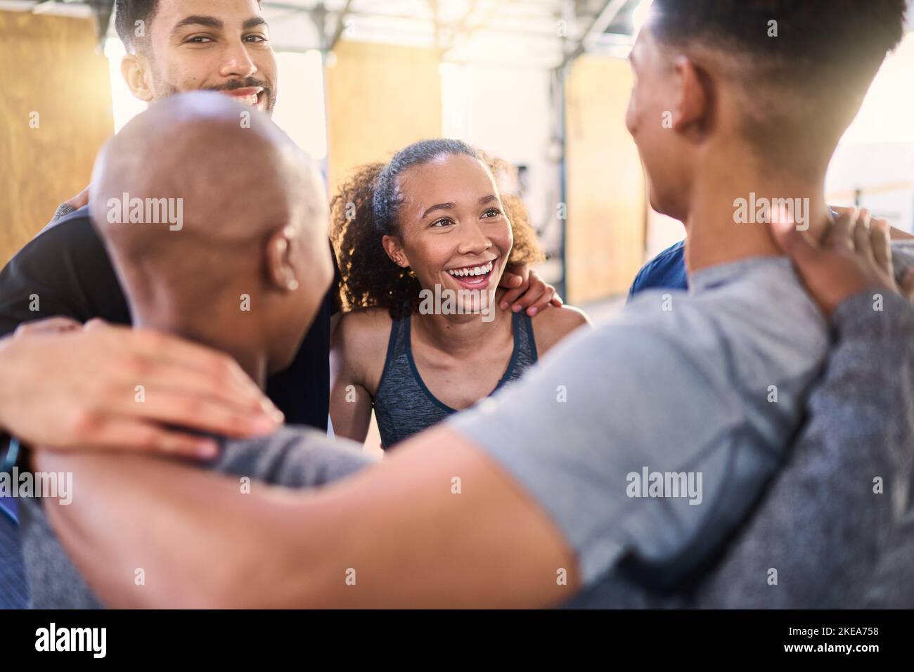 Fitness, class and support hug of gym team and athlete group after ...