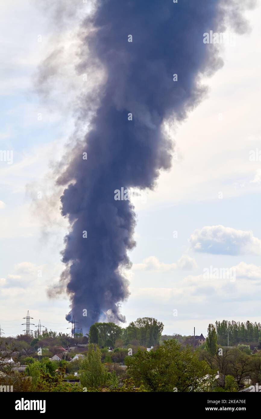 Burning tanks with fuel at the oil depot as a result of a rocket hit ...