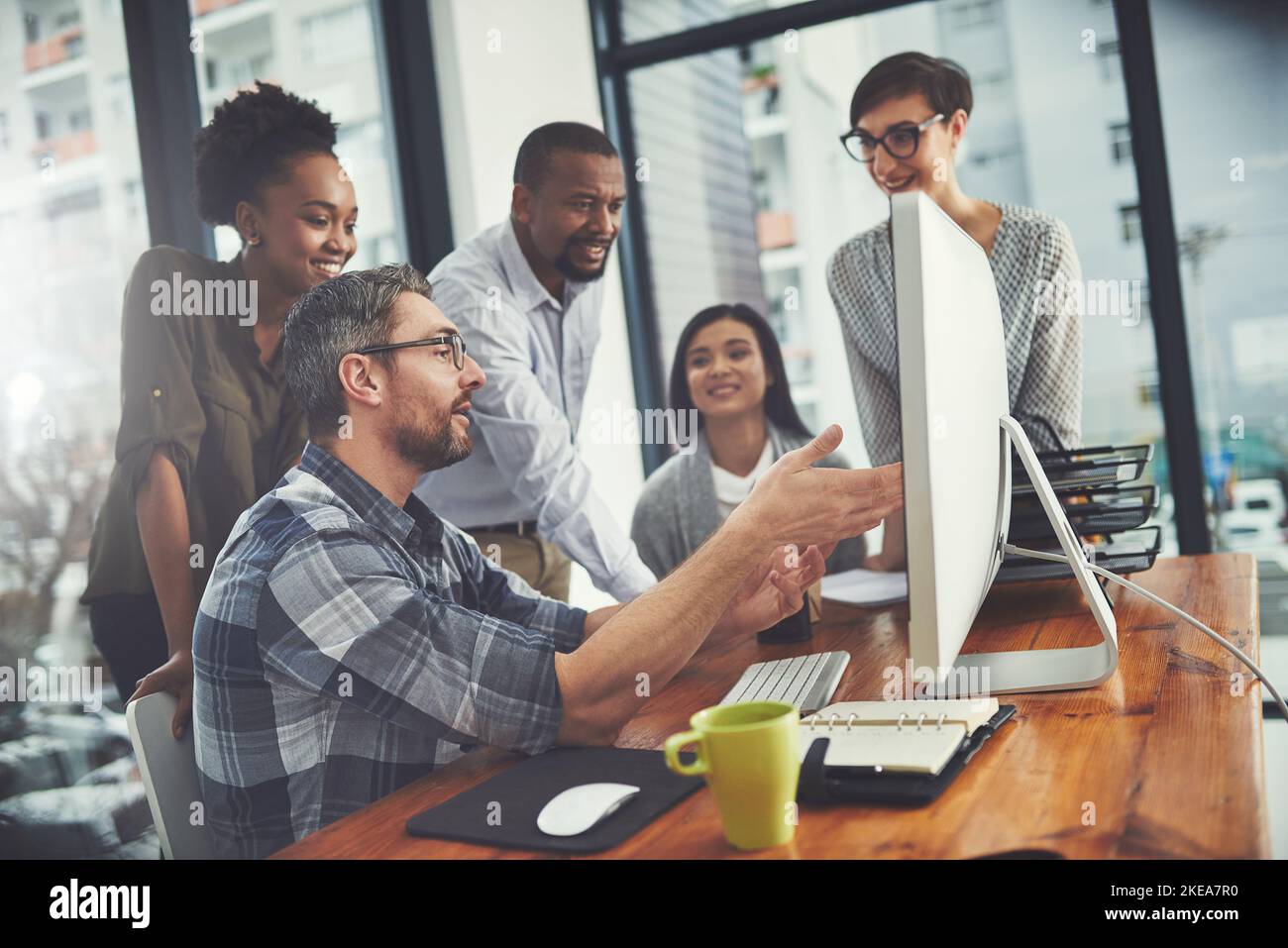 Sharing his vision with the team. a group of businesspeople gathered ...