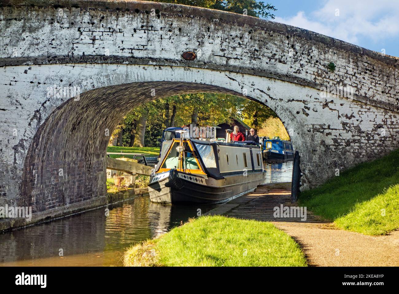 Canal narrowboat passing under a bridge on the Shropshire union canal ...