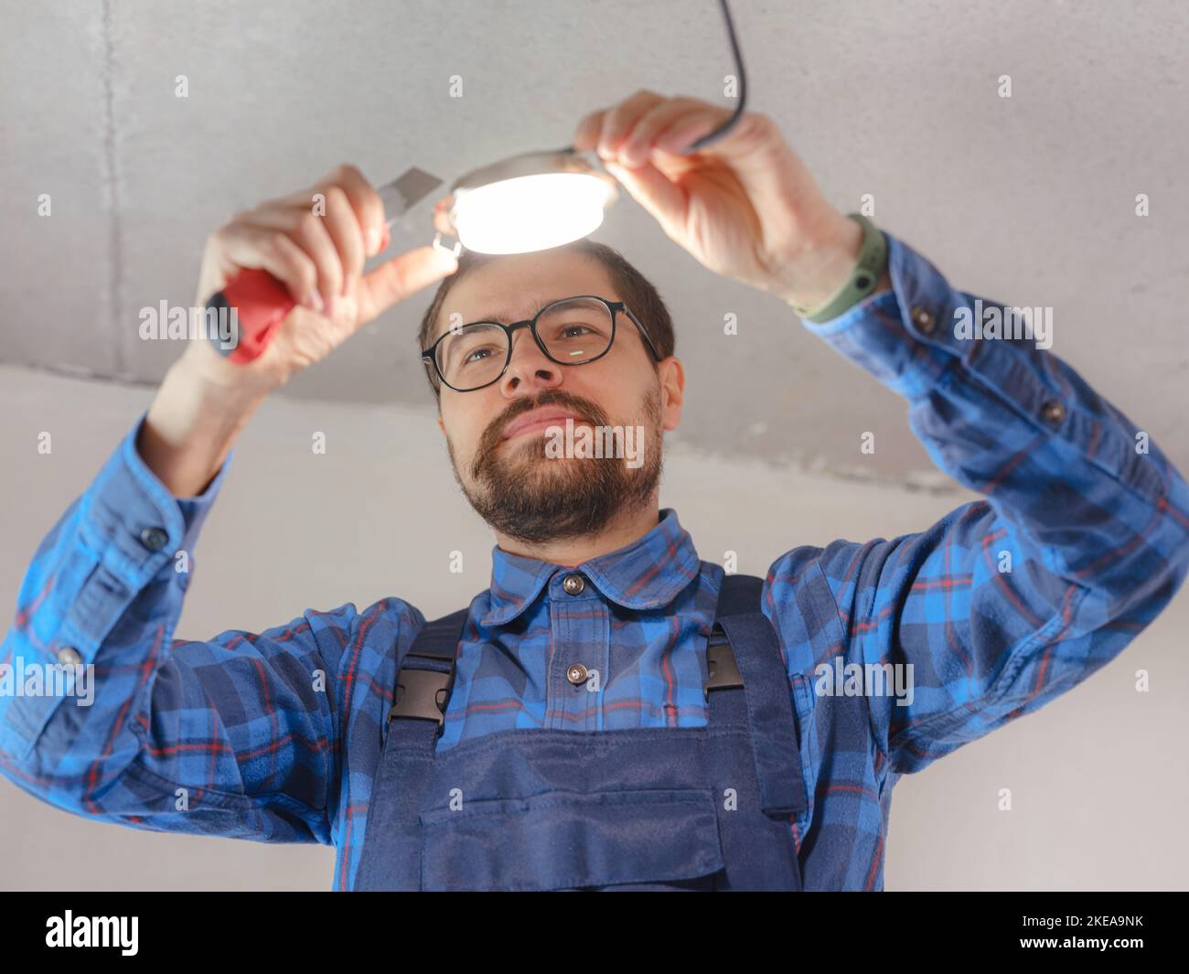 Electrician at work. Service for repair of electrical wiring and ...