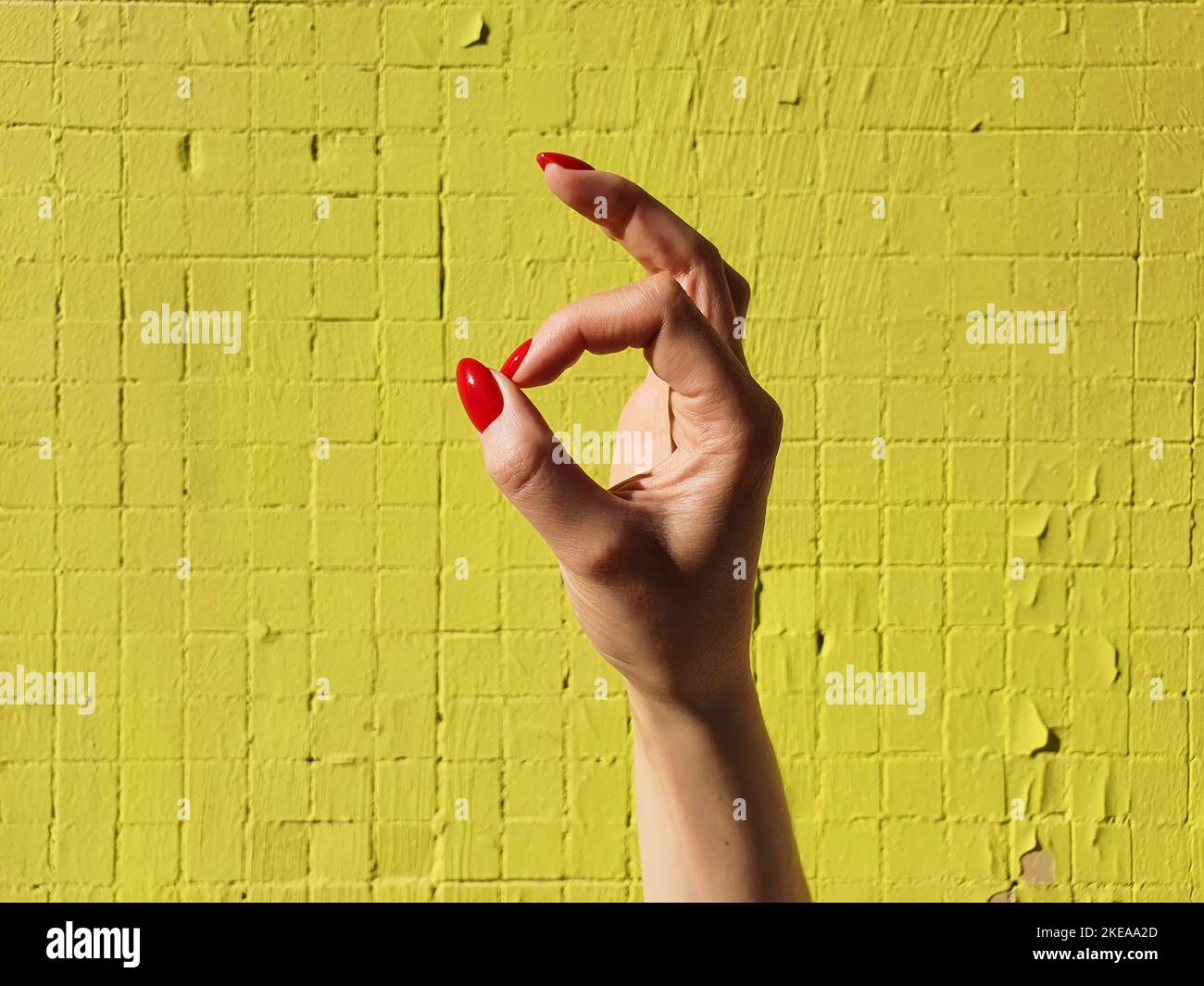Okay hand sign. Female hand with red nails showing okay sign on neon ...