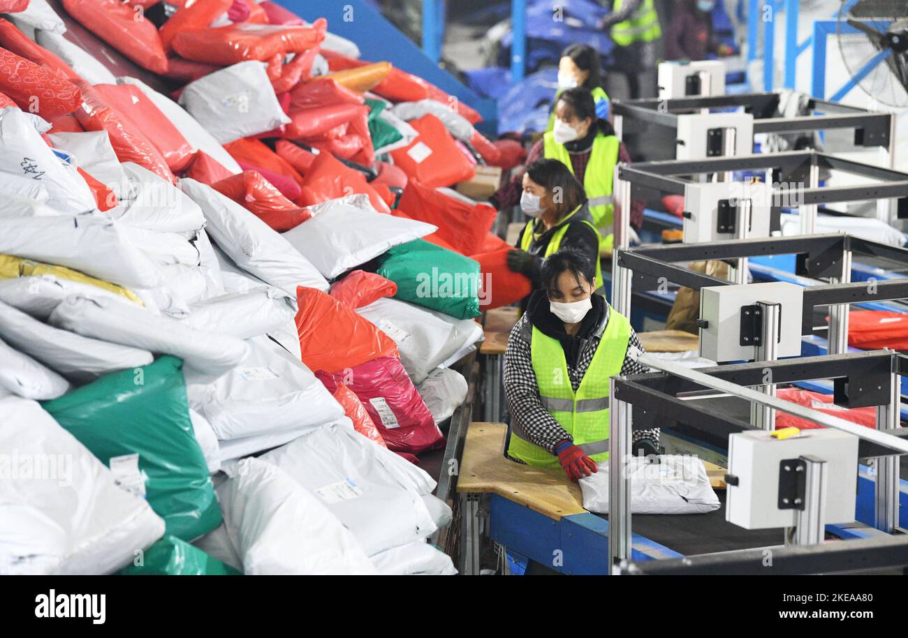 Workers are busy sorting express parcels for the Double 11 shopping ...