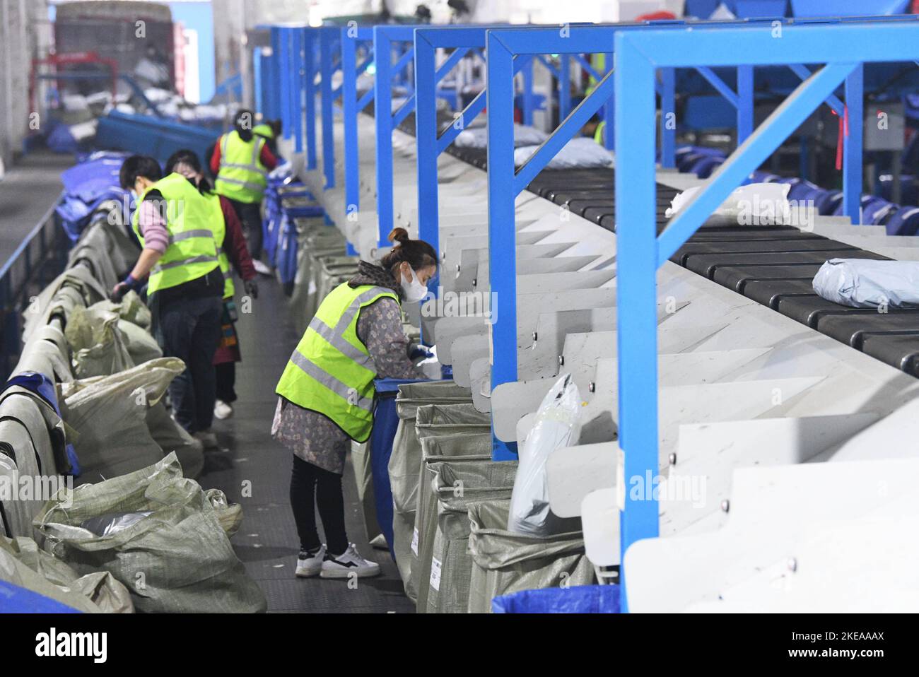 Workers are busy sorting express parcels for the Double 11 shopping ...