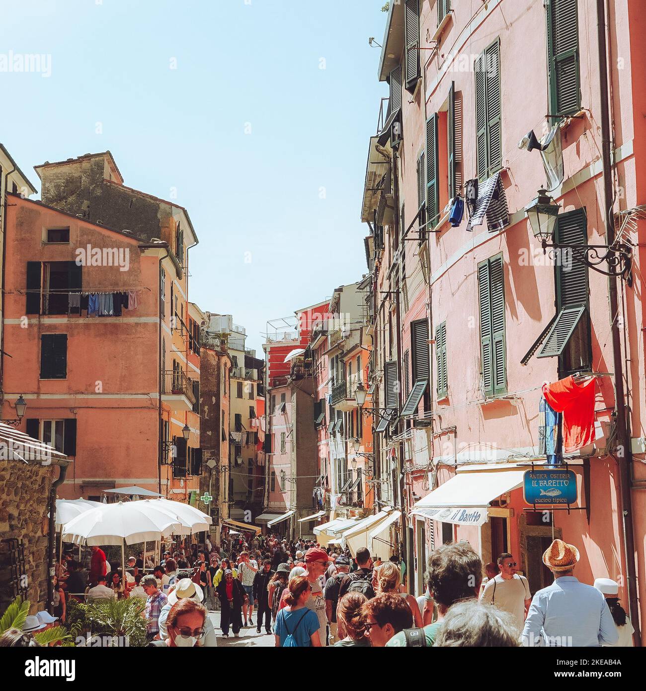 A scenic shot of the narrow crowded street of Cinque Terre in Italy ...