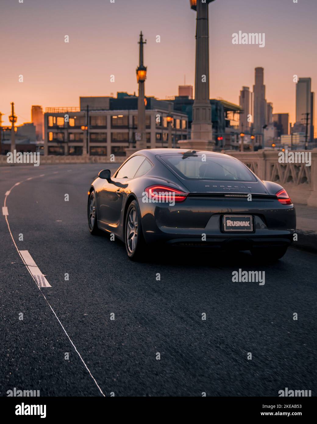 A vertical shot of a Porsche driving on the 6th street bridge in ...