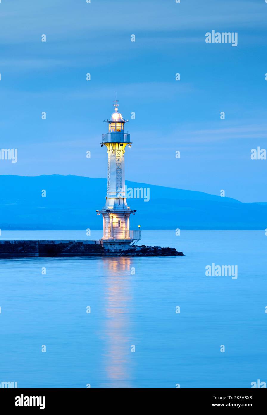 Leuchtturm bei der Hafenmauer am Genfer Seebecken in der Abenddämmerung ...