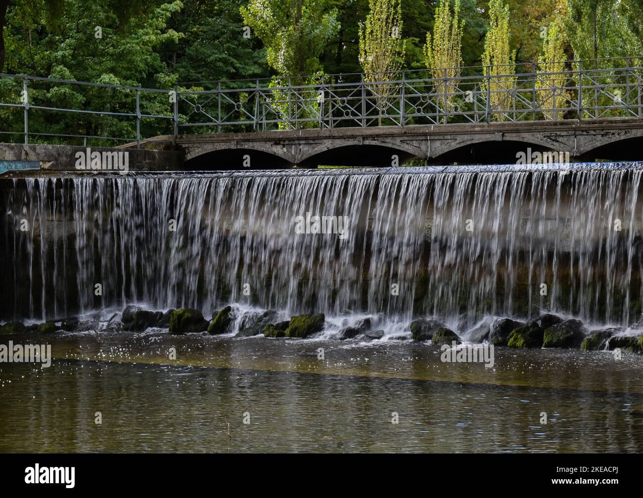 Small waterfall under the bridge Stock Photo - Alamy