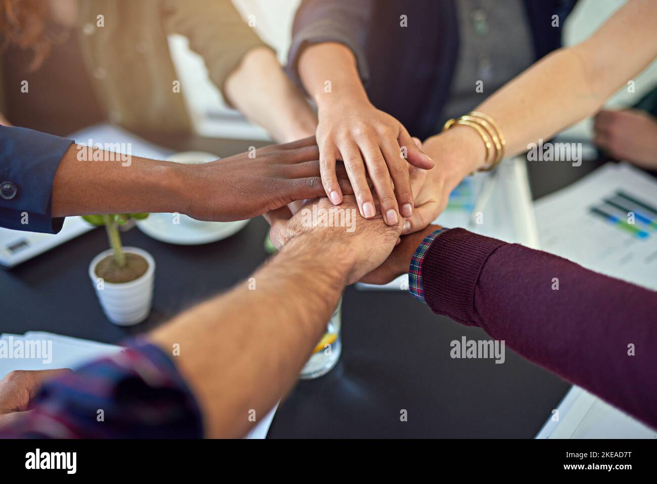 Motivating and strengthening partnerships. Closeup shot of a group of businesspeople joining ...