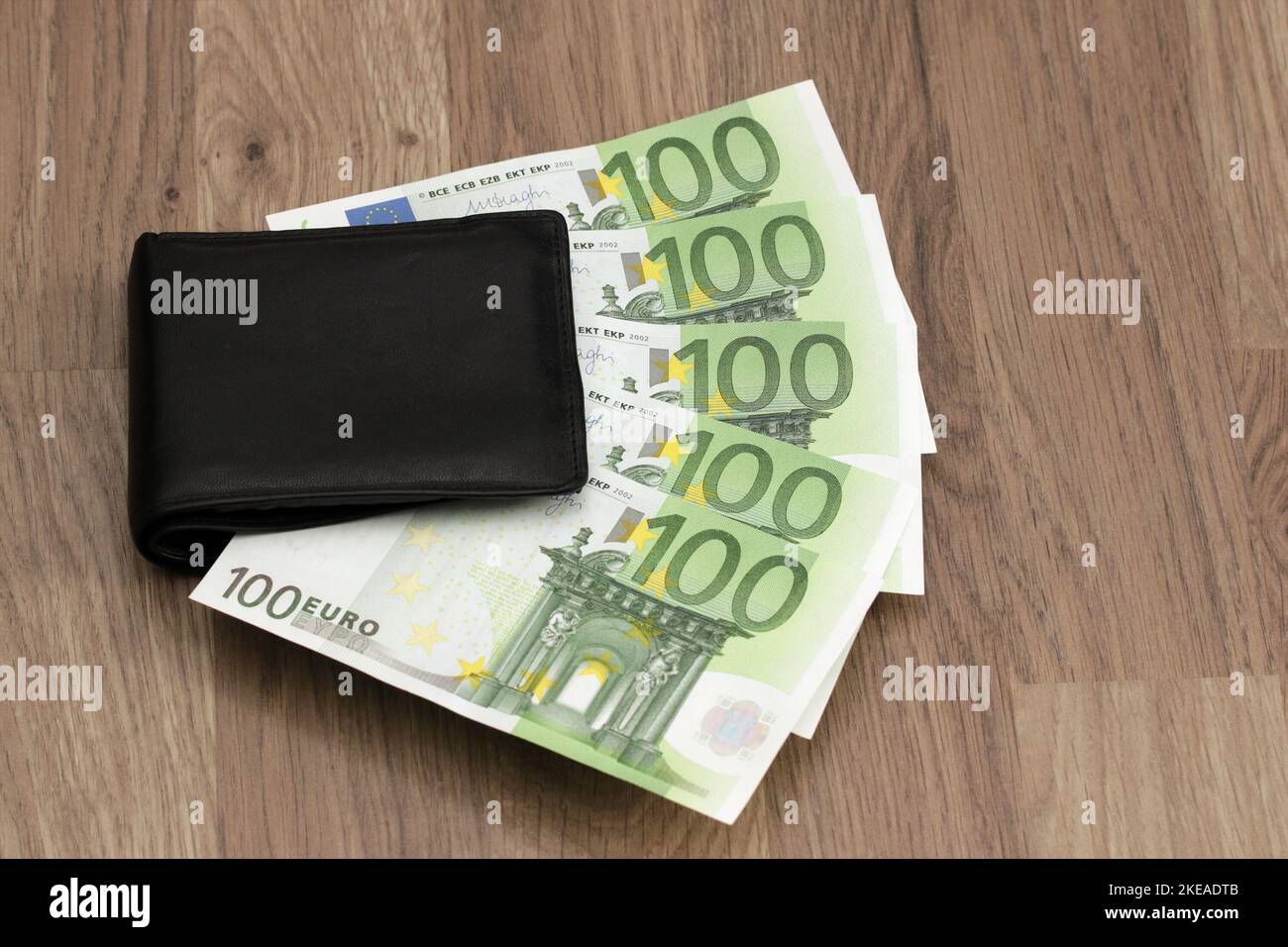 500 euros sticking out of the wallet. Five paper banknotes of 100 euros ...