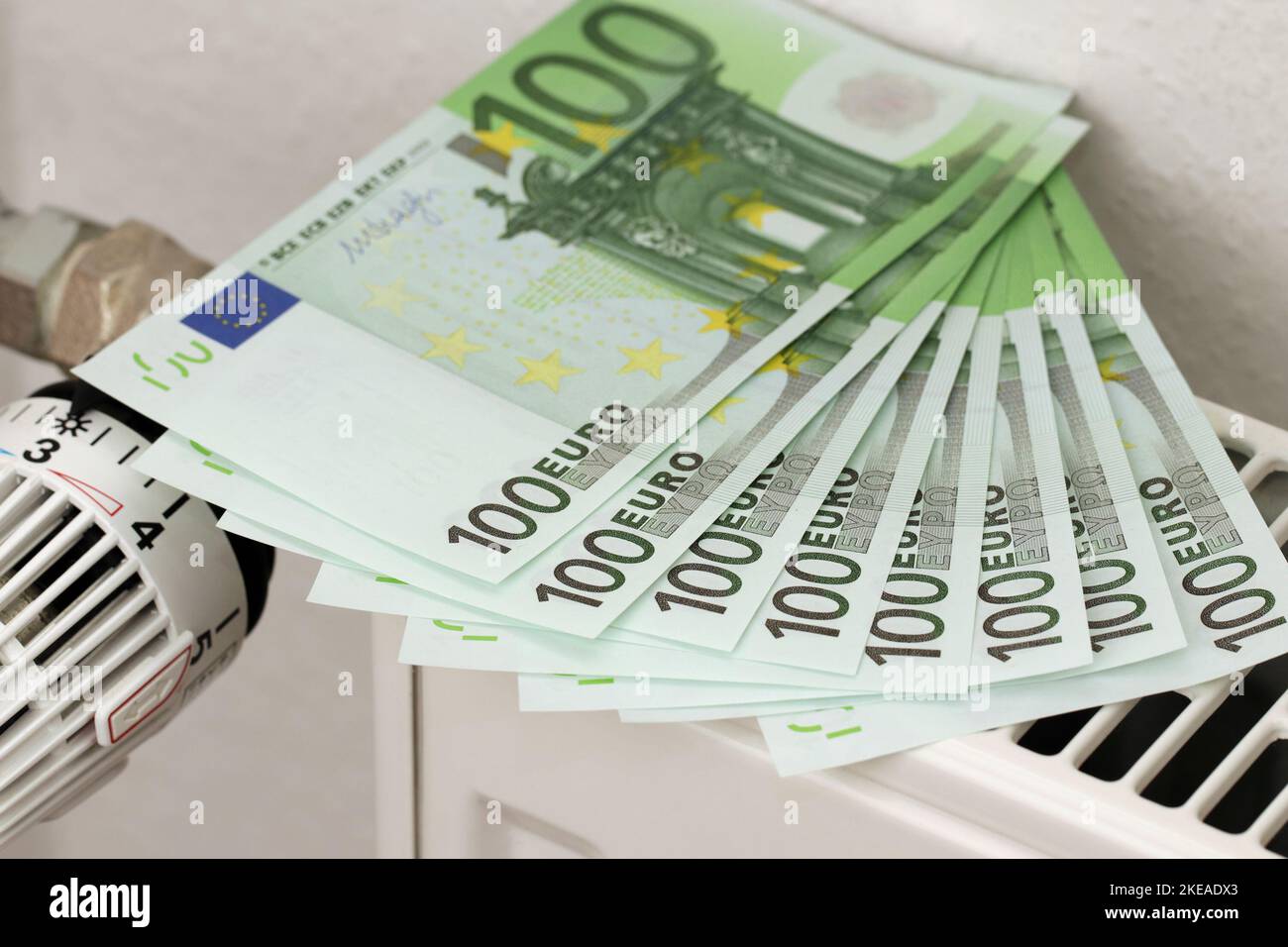 100 Euro paper banknotes lie on the heating radiator. A symbol of ...