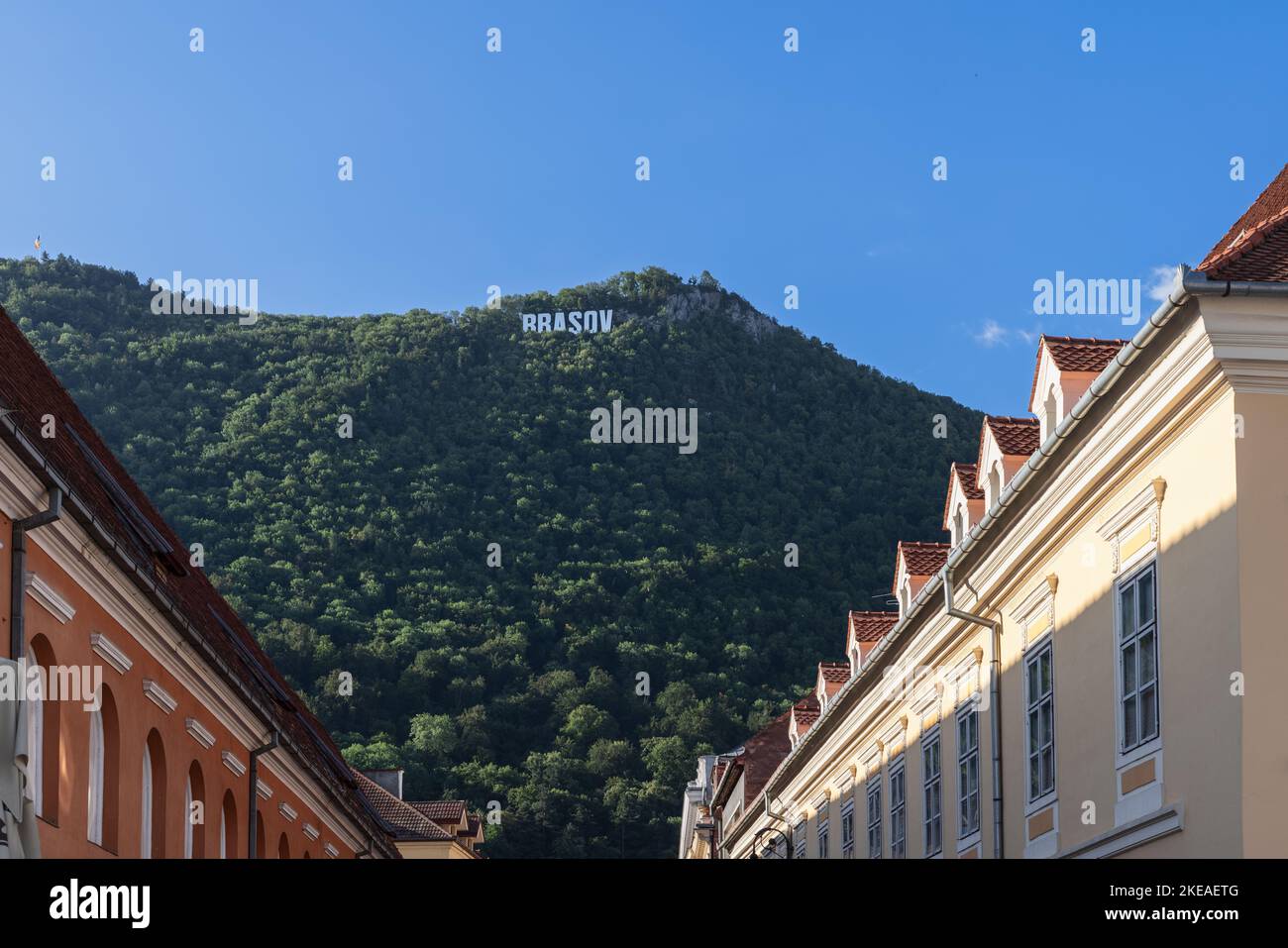 City name Brasov written with huge white letters on top of forested ...