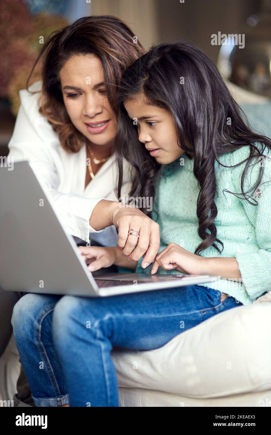 Whos introducing who to technology. a little girl and her mother using a laptop together at home ...