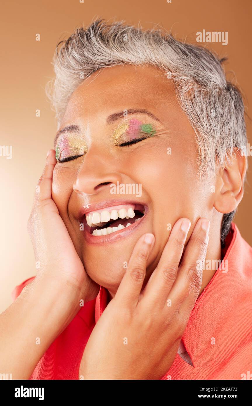 Happy, color and senior woman with makeup standing in a studio with ...