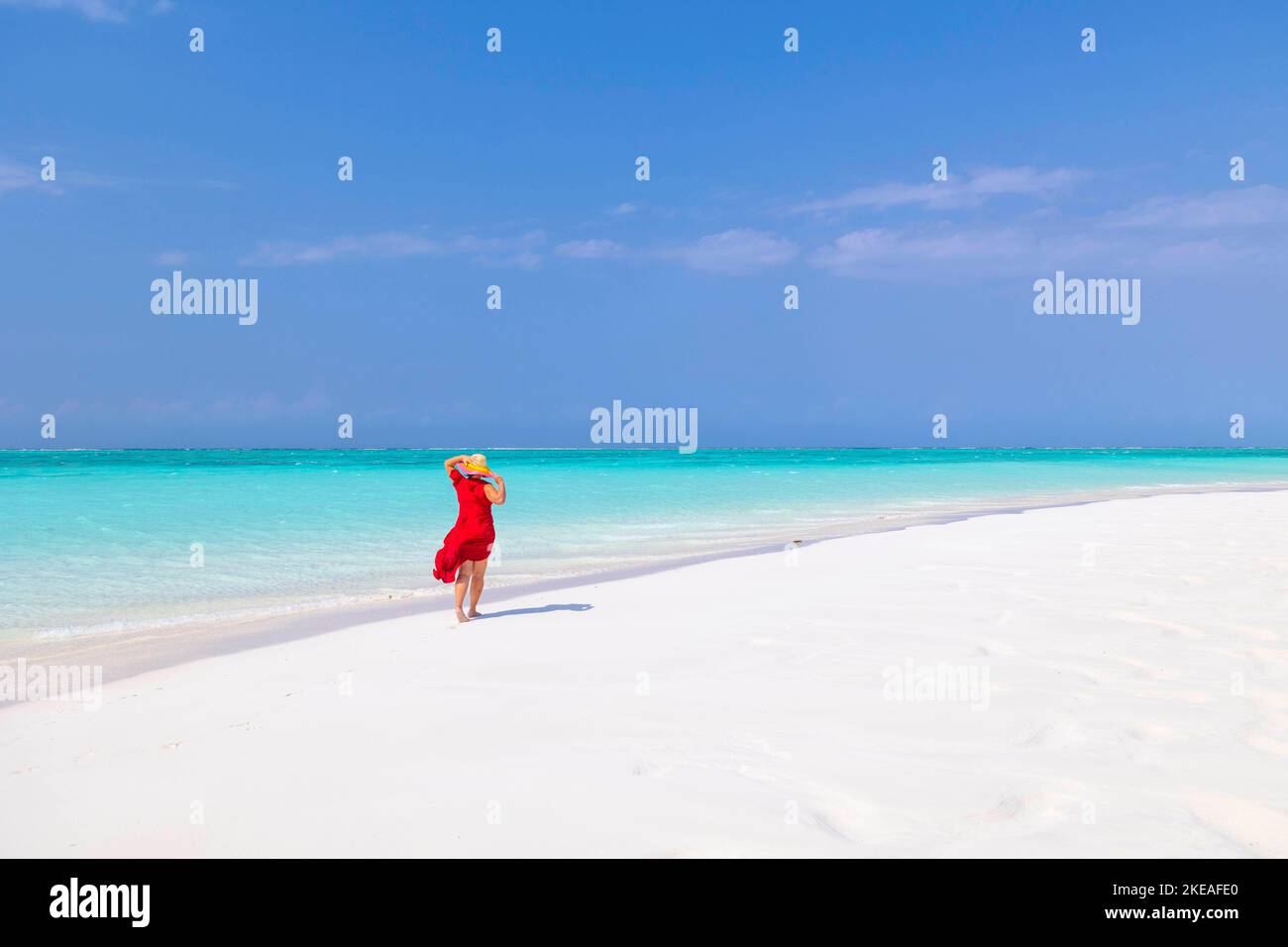 one tourist walking on the beach during a sunny day, Zanzibar, Tanzania ...