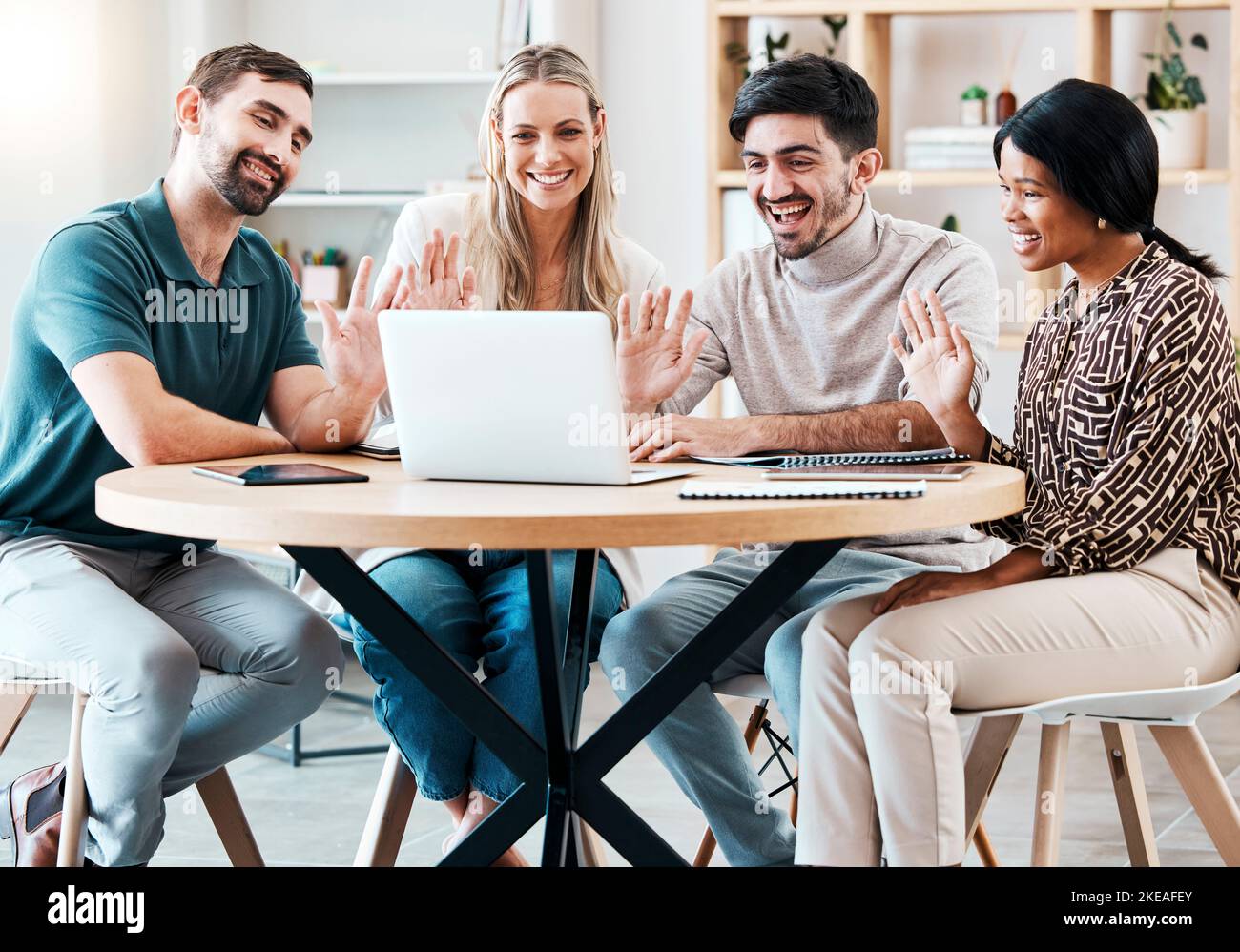 Team sitting at desk together for online meeting, video call or webinar ...