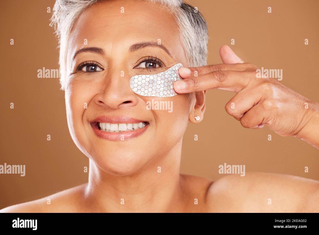 Senior woman, skincare and beauty with a eye patch or collagen mask for ...