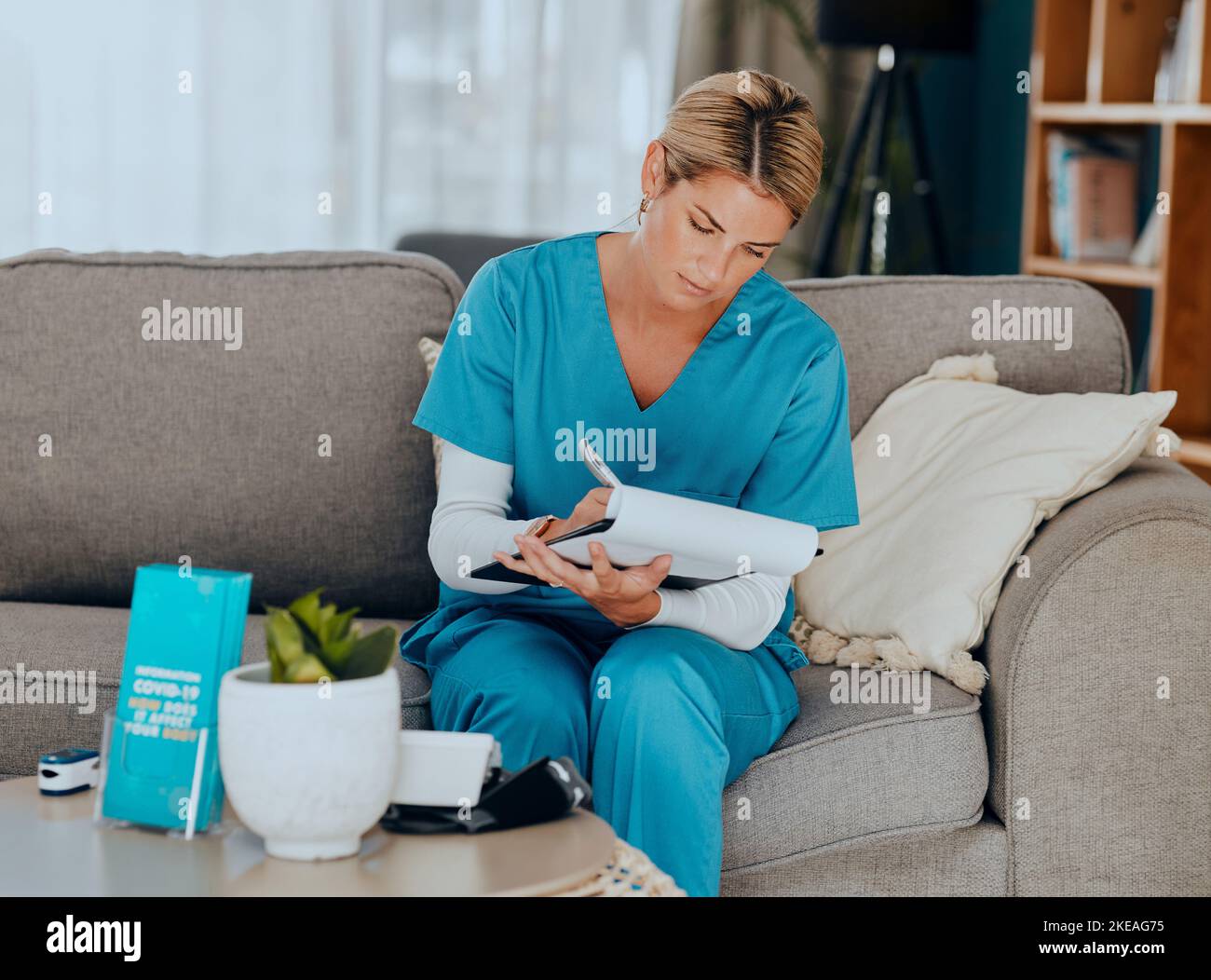 Medical, sofa and nurse writing notes in living room at home care with ...