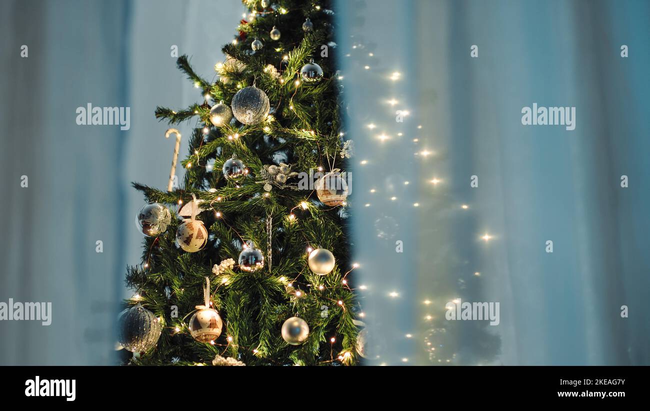 Illuminated Christmas tree behind the window Stock Photo - Alamy