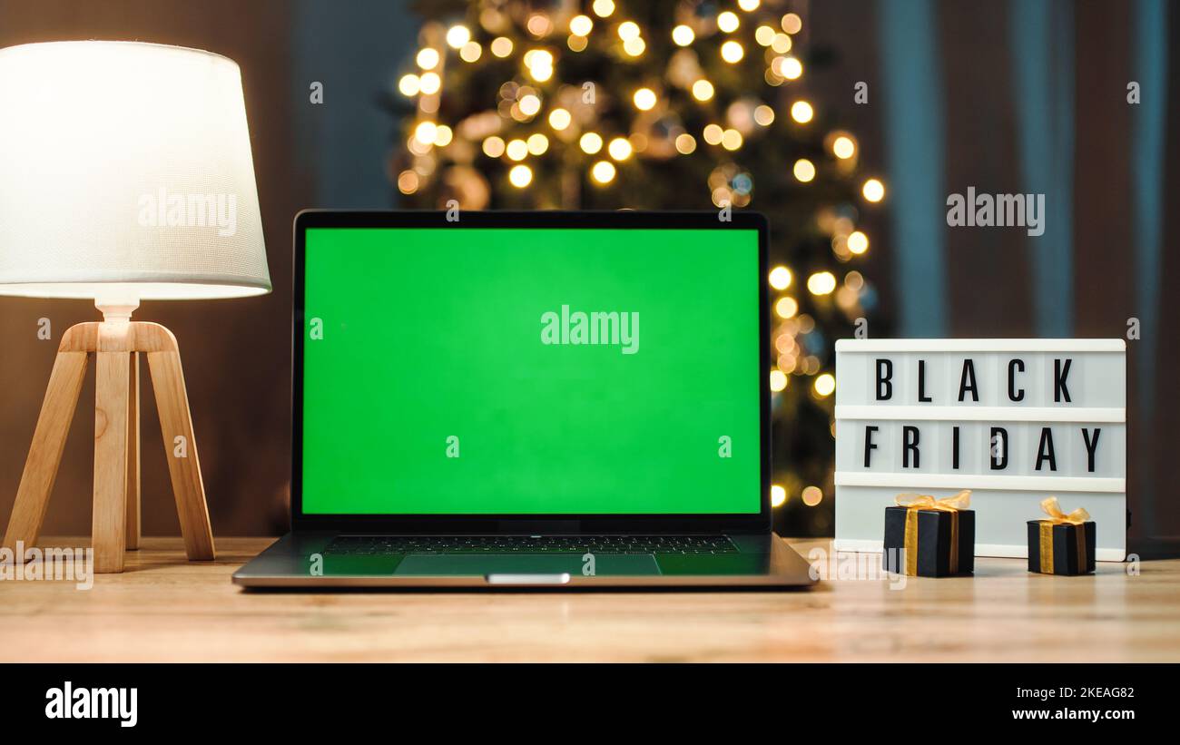 Notebook with green screen near black friday sign on desk Stock Photo ...