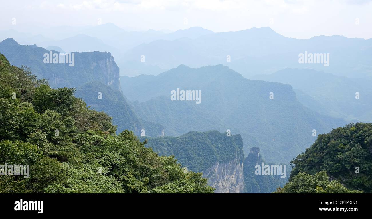 A panoramic aerial of beautiful green mountain ranges fading with the ...