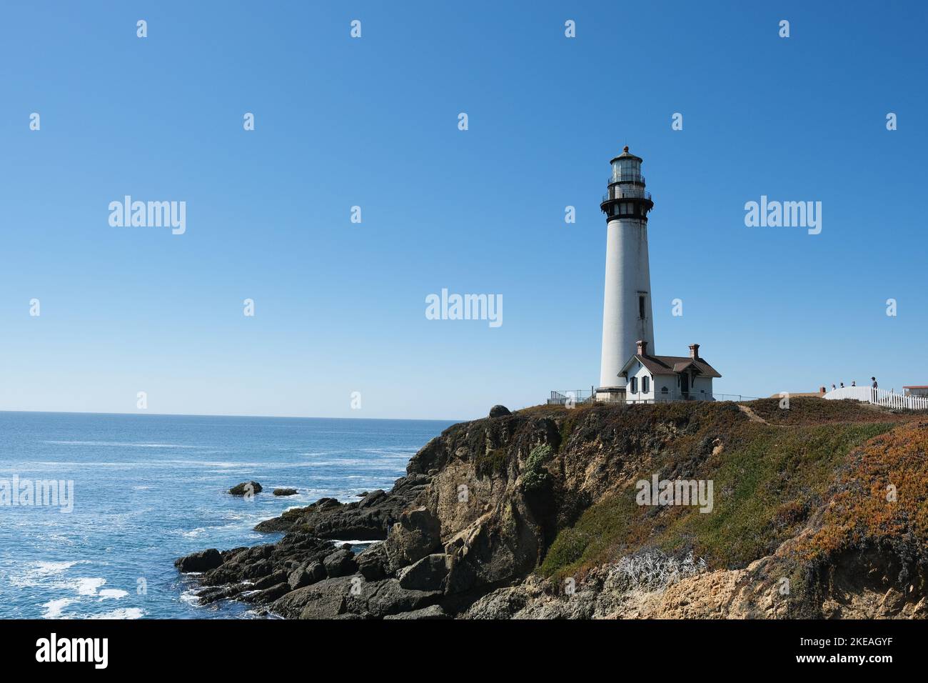 A beautiful shot of a lighthouse on a rocky cliff by a beach Stock ...