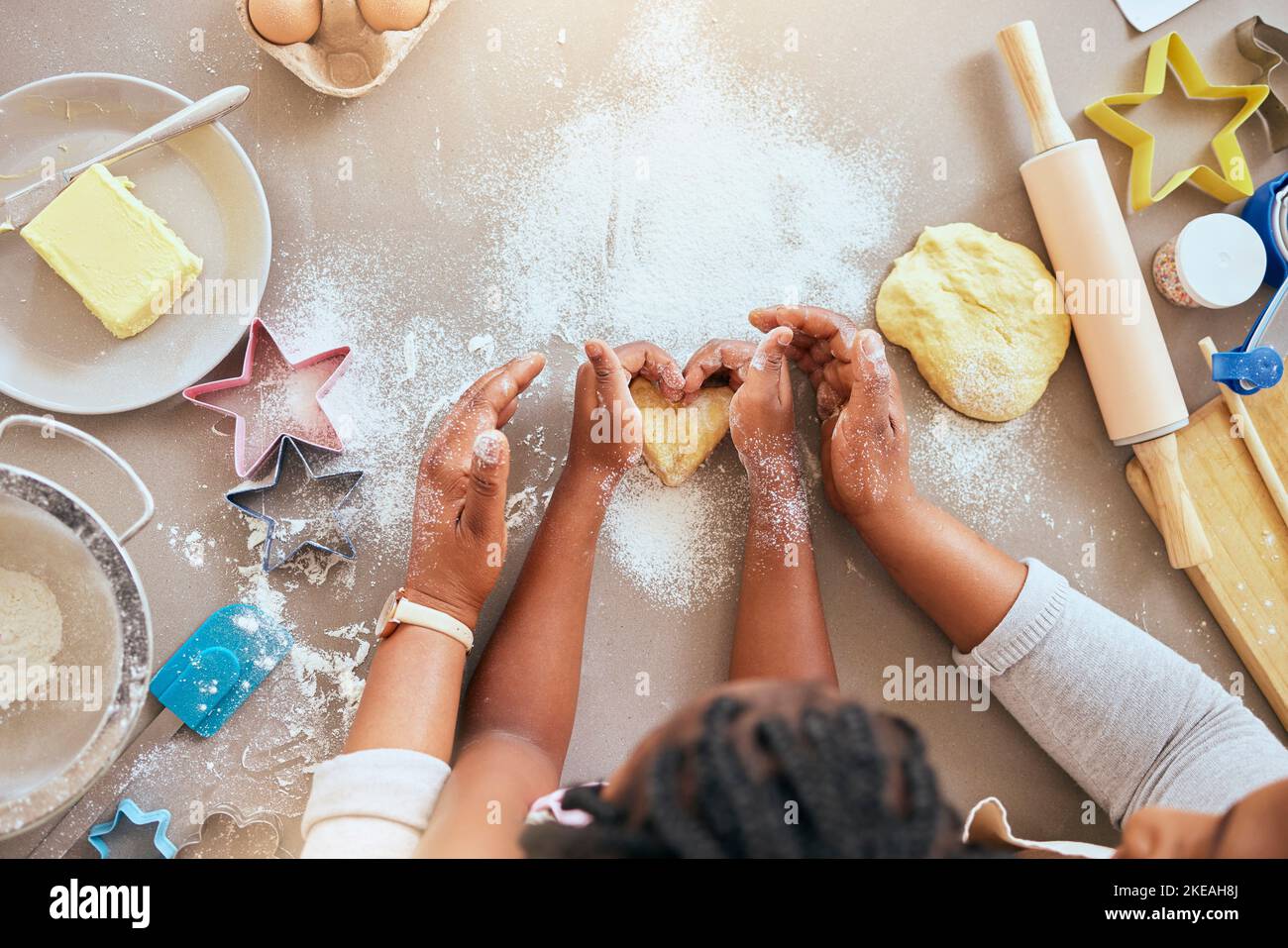 Black woman, child hands or kitchen baking of heart shape pastry, house ...