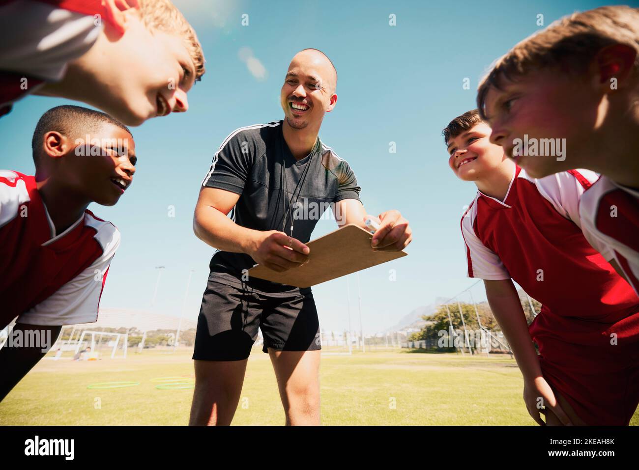 Coach, soccer and team strategy on field for athlete children excited ...