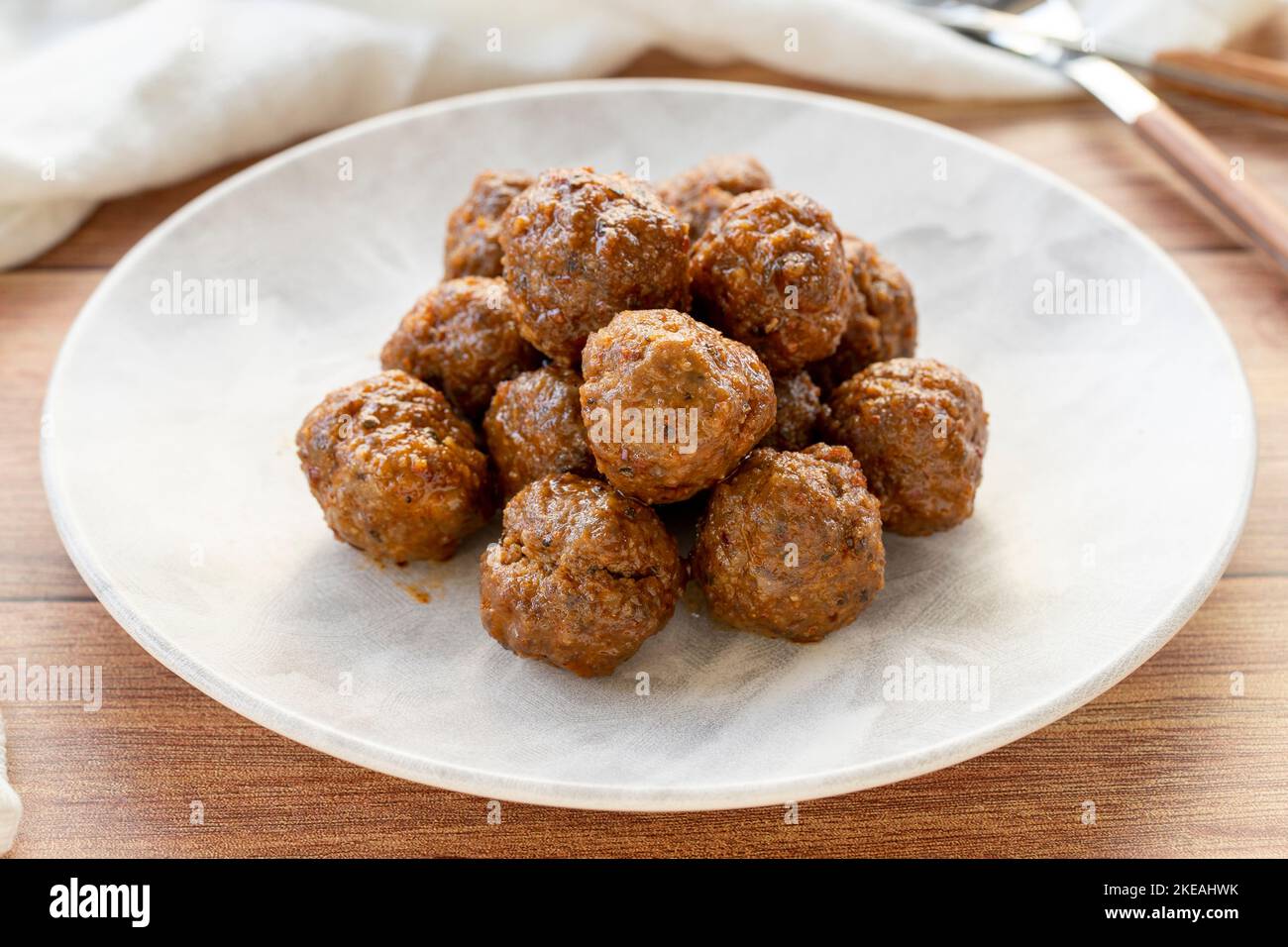 Baked homemade meatballs on wood floor. Local name misket kofte. close ...