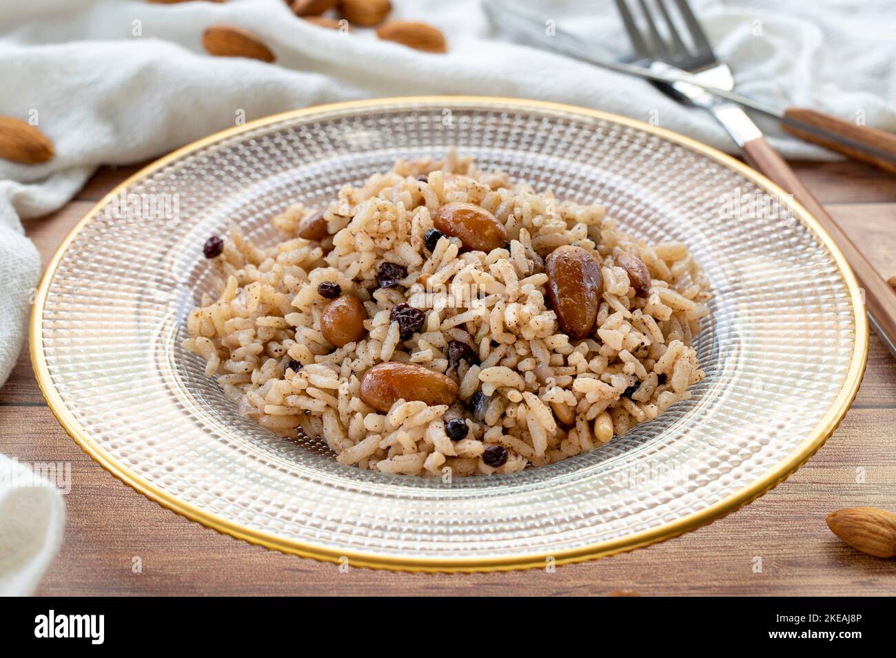 Rice with currants and almonds on a wood background. Traditional ...
