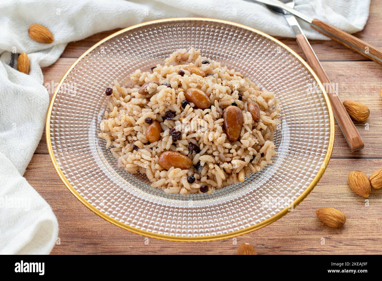 Rice with currants and almonds on a wood background. Traditional ...