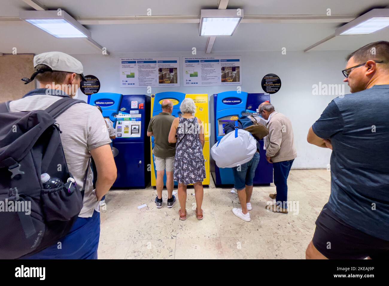 Group of passengers waiting in front of vending machines to get their ...