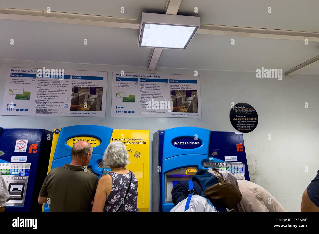 Group of passengers waiting in front of vending machines to get their ...