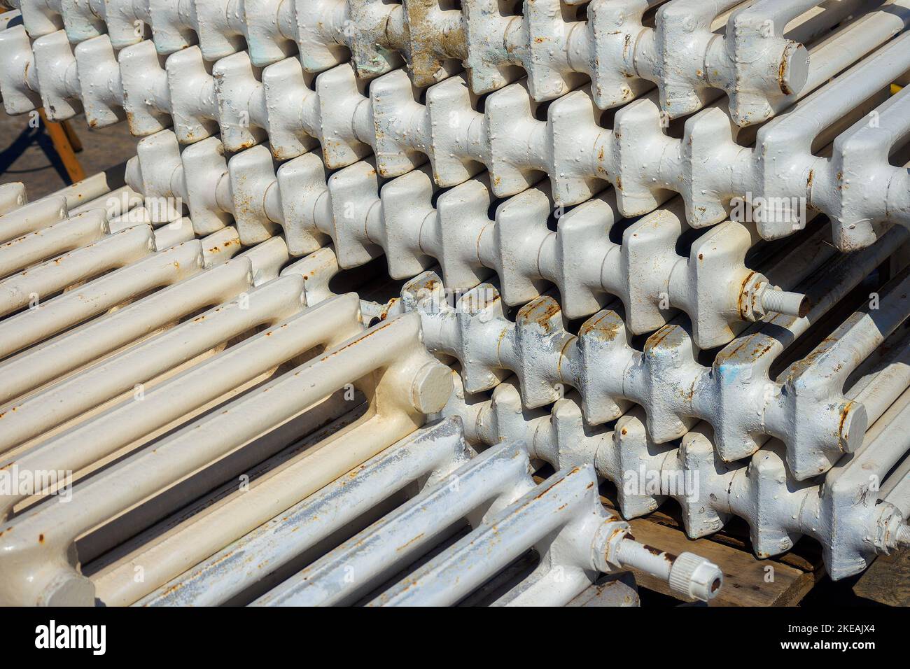 Old cast iron batteries or heating radiators stacked. Scrap metal and ...