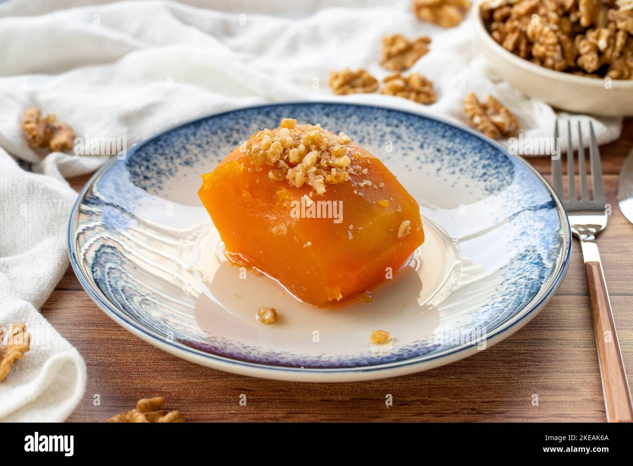 Turkish pumpkin dessert on wood floor. Traditional Turkish cuisine ...