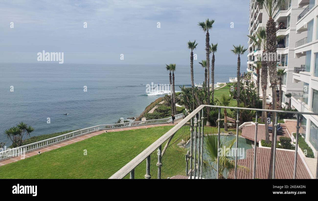 A scenic shot of the seascape from a balcony with a building on the ...
