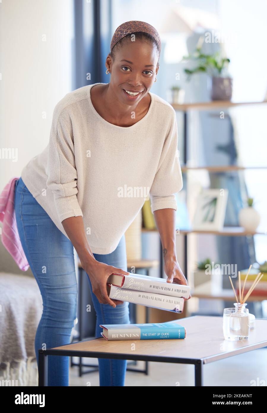 Cleaning, housework and books with a black woman cleaner packing in a ...