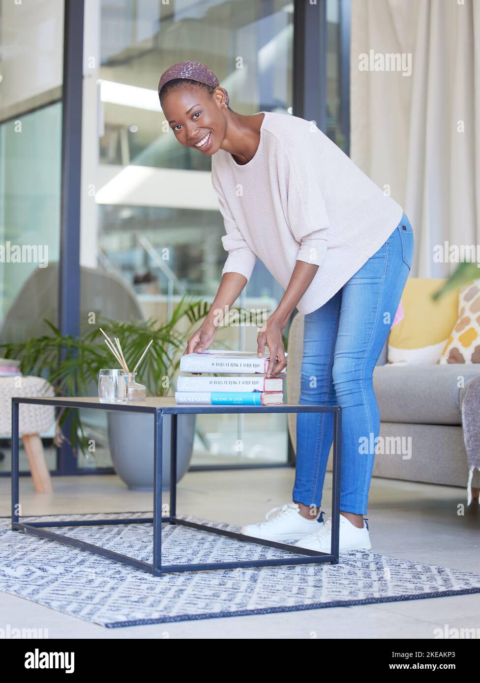 Black woman, books and portrait of student in living room pick up book ...