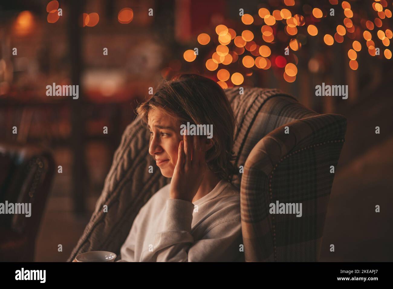 Young teen boy with long hair thoughtful look sad eyes negative mood ...