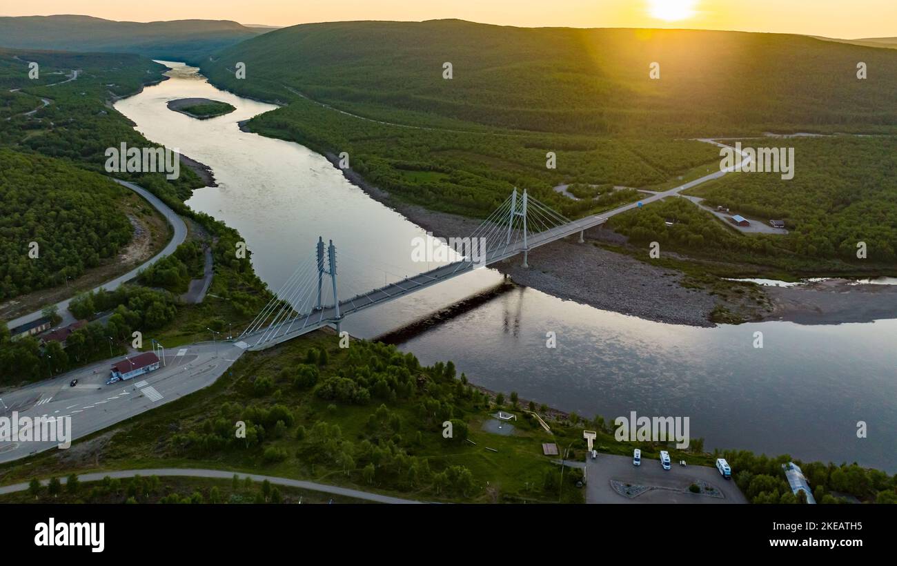 Aerial view of the Sami Bridge and Teno river, summer, golden hour in ...